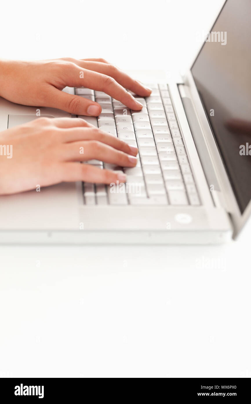 Two hands lying on keyboard of laptop Stock Photo - Alamy