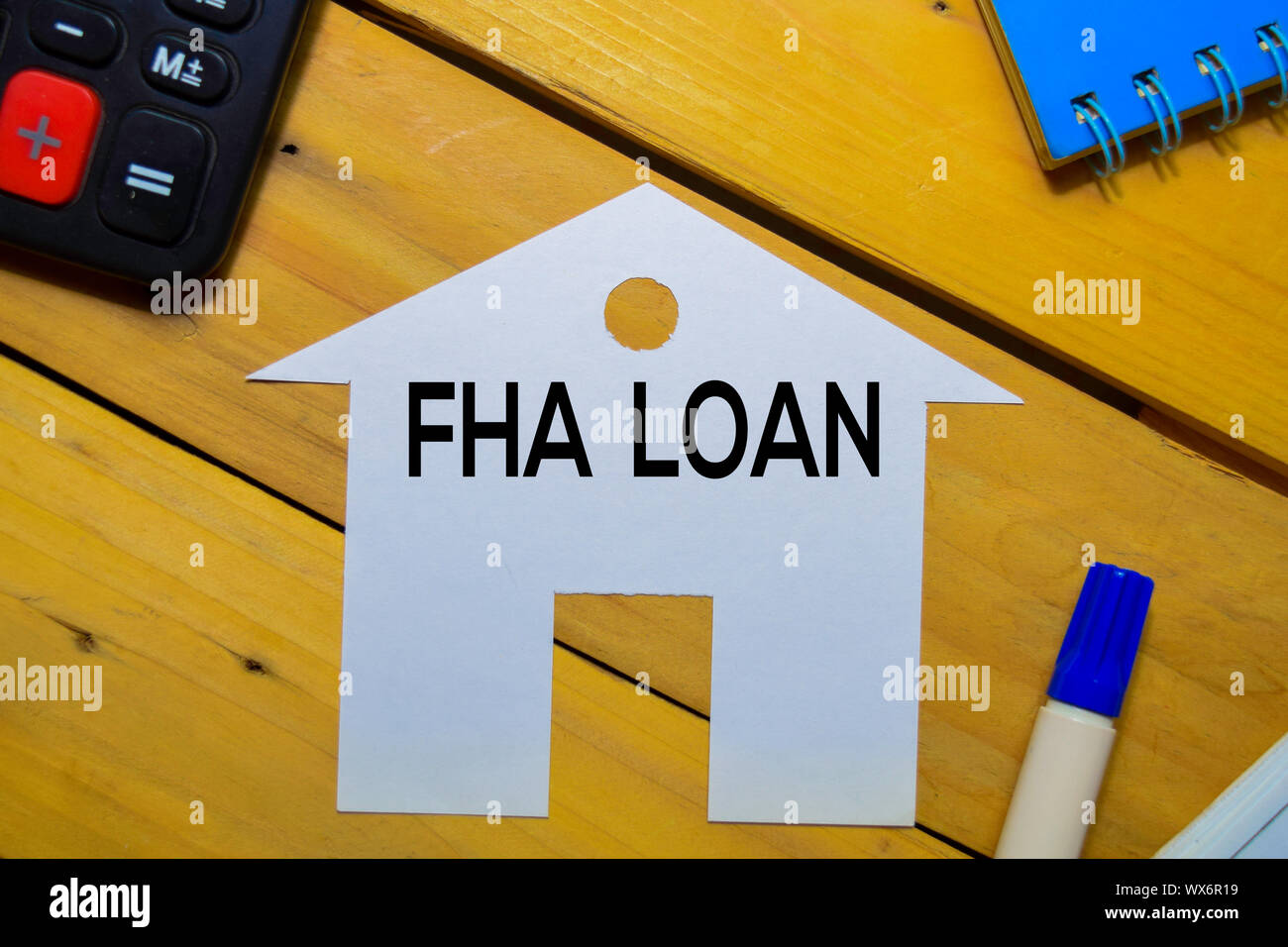 FHA Loan text on paper house isolated on office desk Stock Photo - Alamy