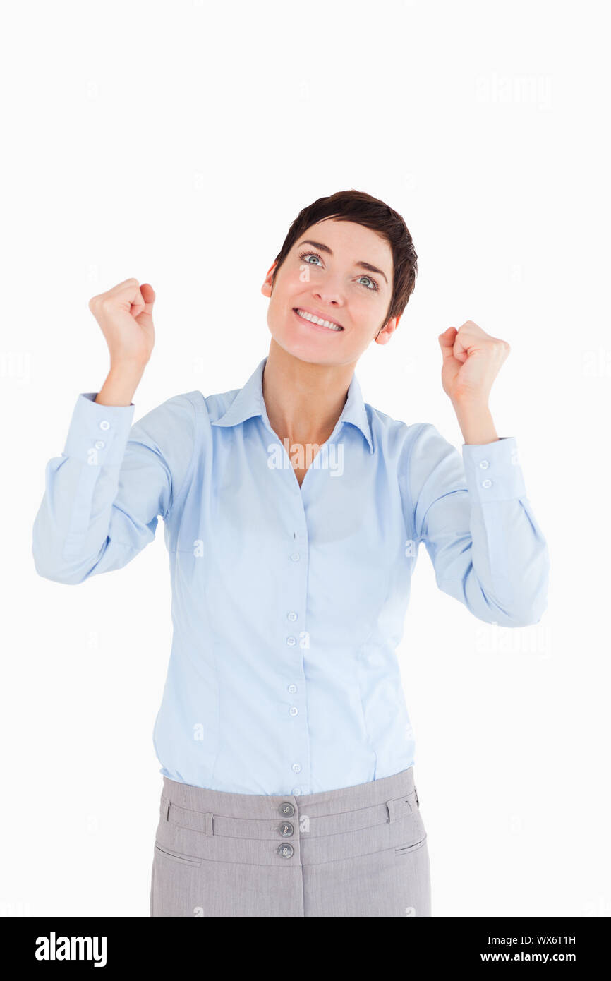 Happy businesswoman with the fists up against a white background Stock ...