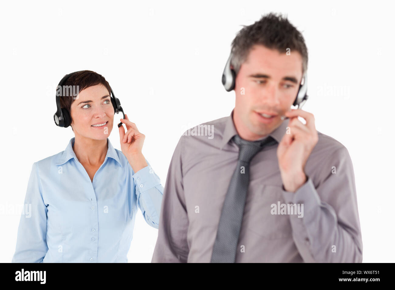 Business people using headsets against a white background Stock Photo ...