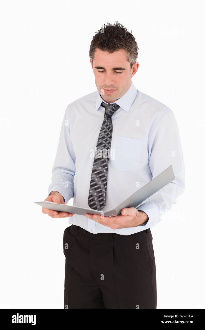 Portrait of a man looking a binder against a white background Stock ...