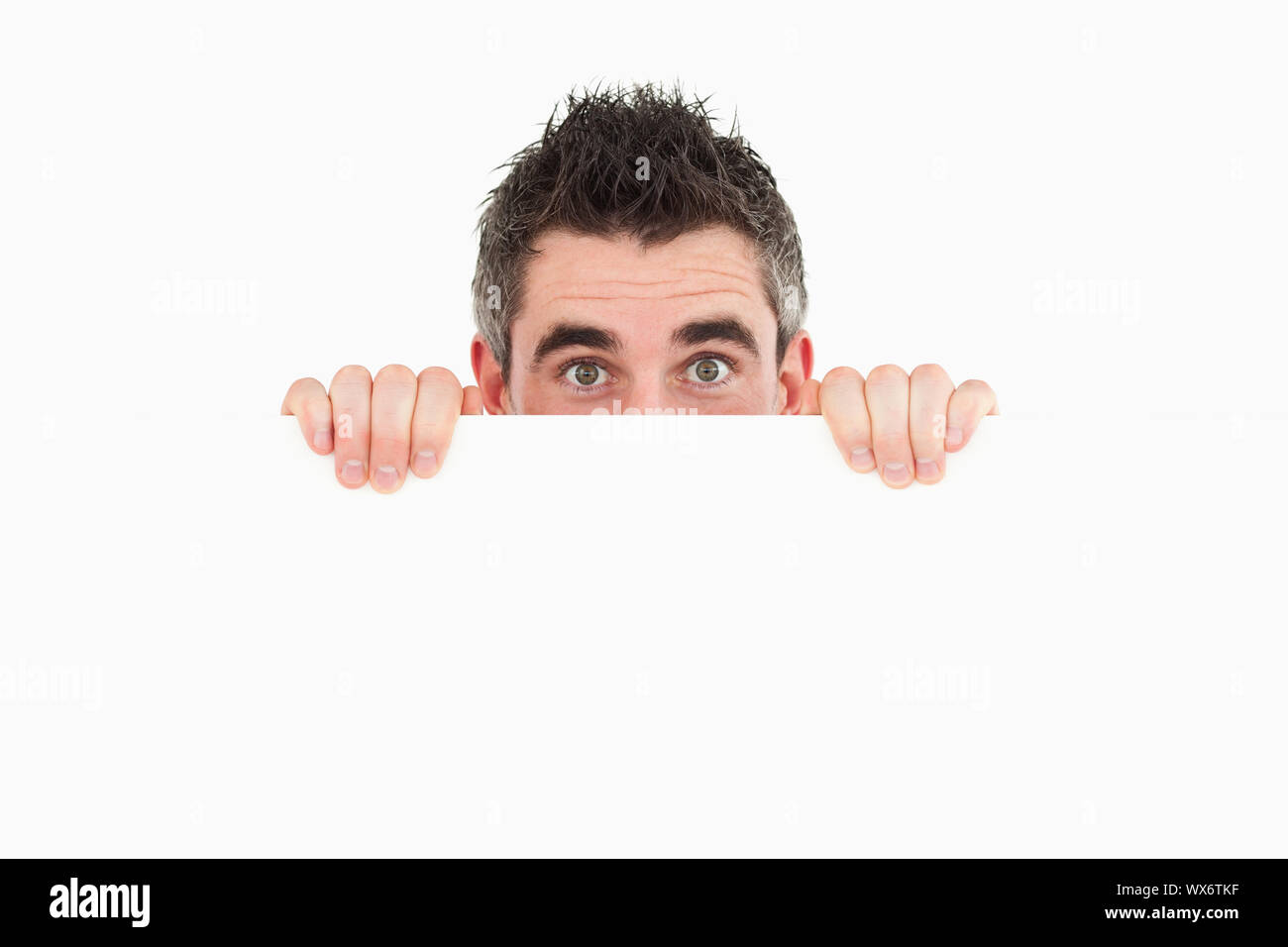 Businessman hiding behind wall hi-res stock photography and images - Alamy