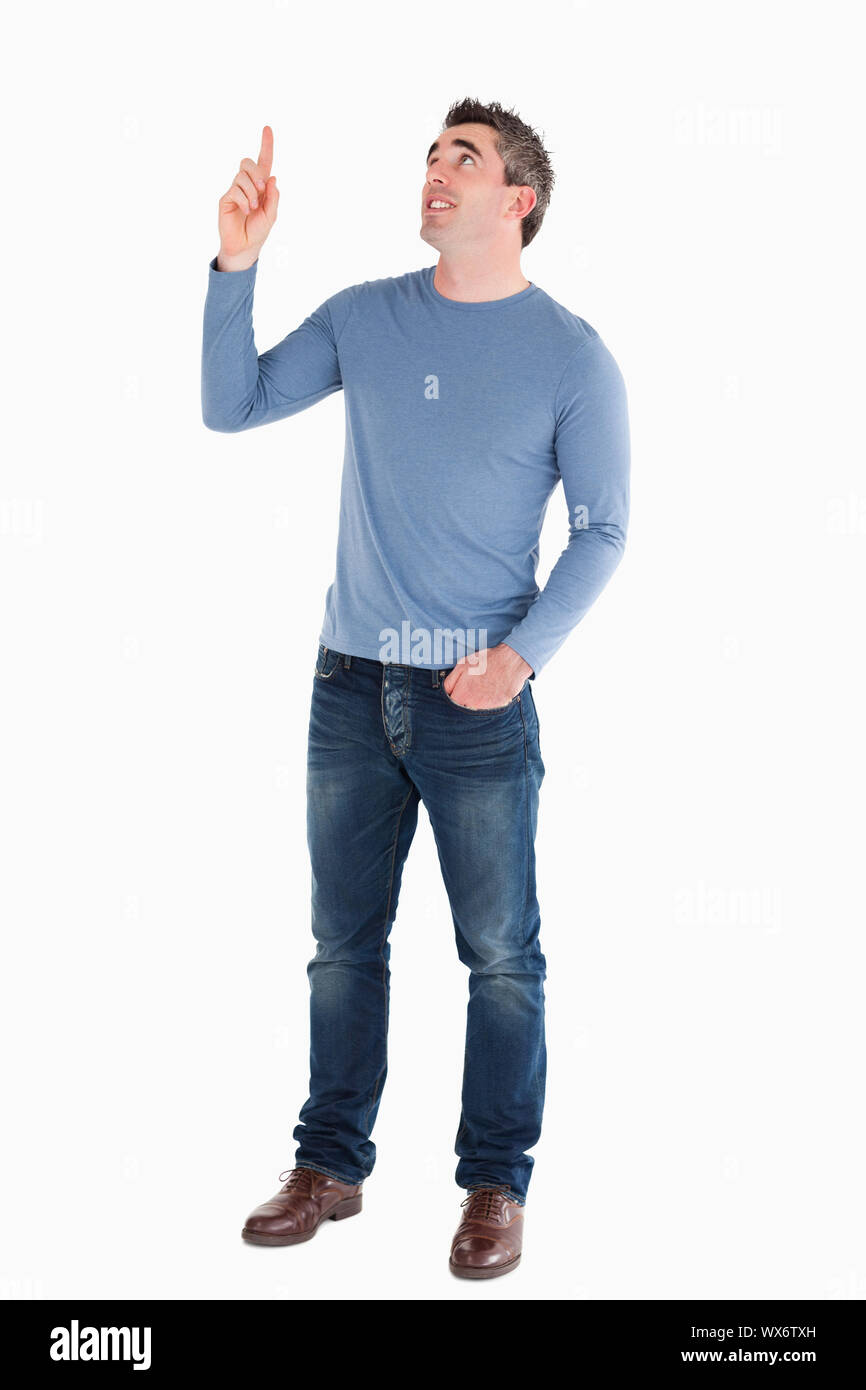 Handsome man pointing at copy space against white background Stock ...