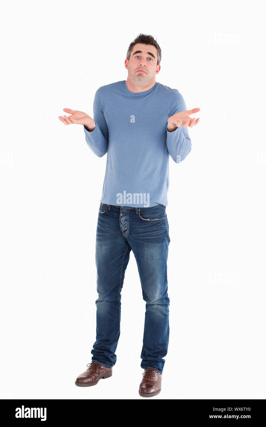 Clueless man posing against a white background Stock Photo - Alamy