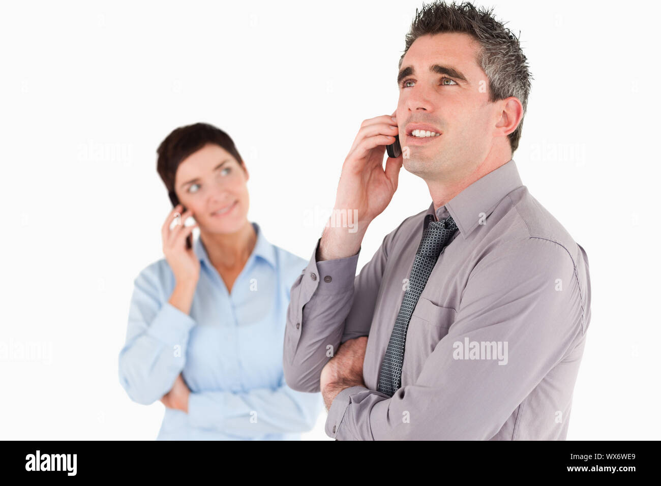 Coworkers making a phone call against a white background Stock Photo ...