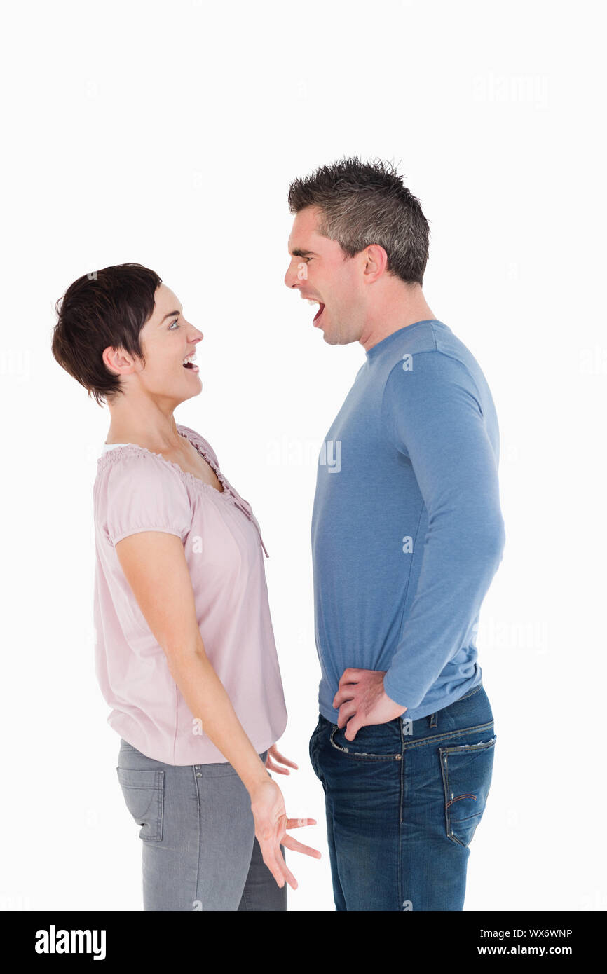 Couple having an argument against a white background Stock Photo - Alamy