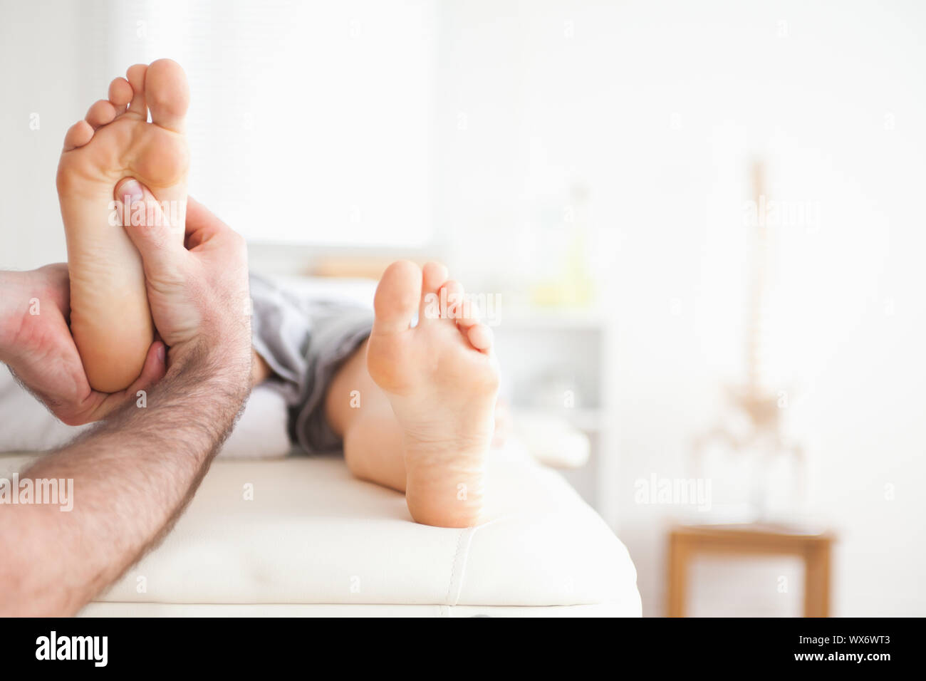 Male masseur doing a reflexology massage in a room Stock Photo - Alamy