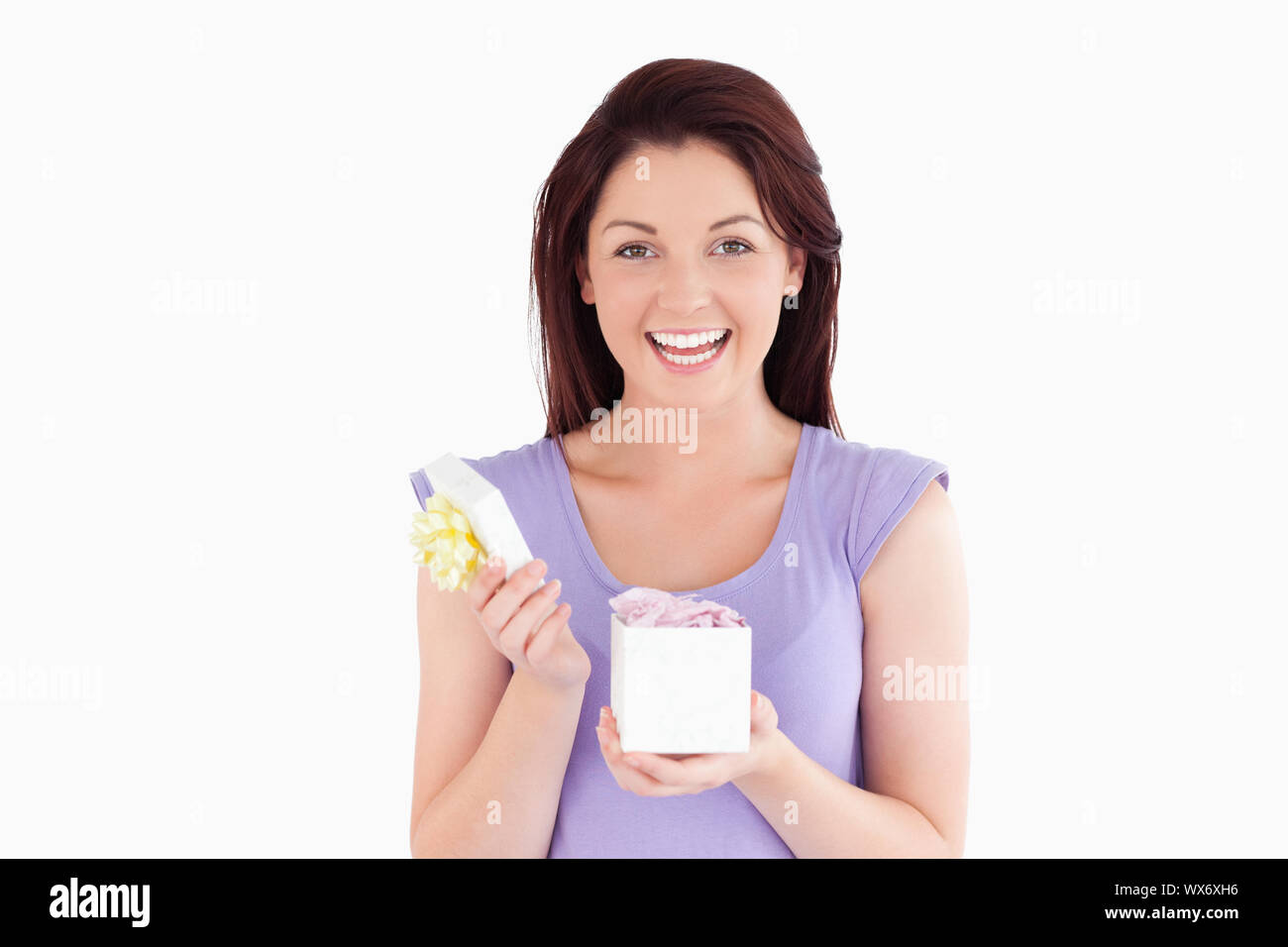 Charming woman opening a box in a studio Stock Photo - Alamy
