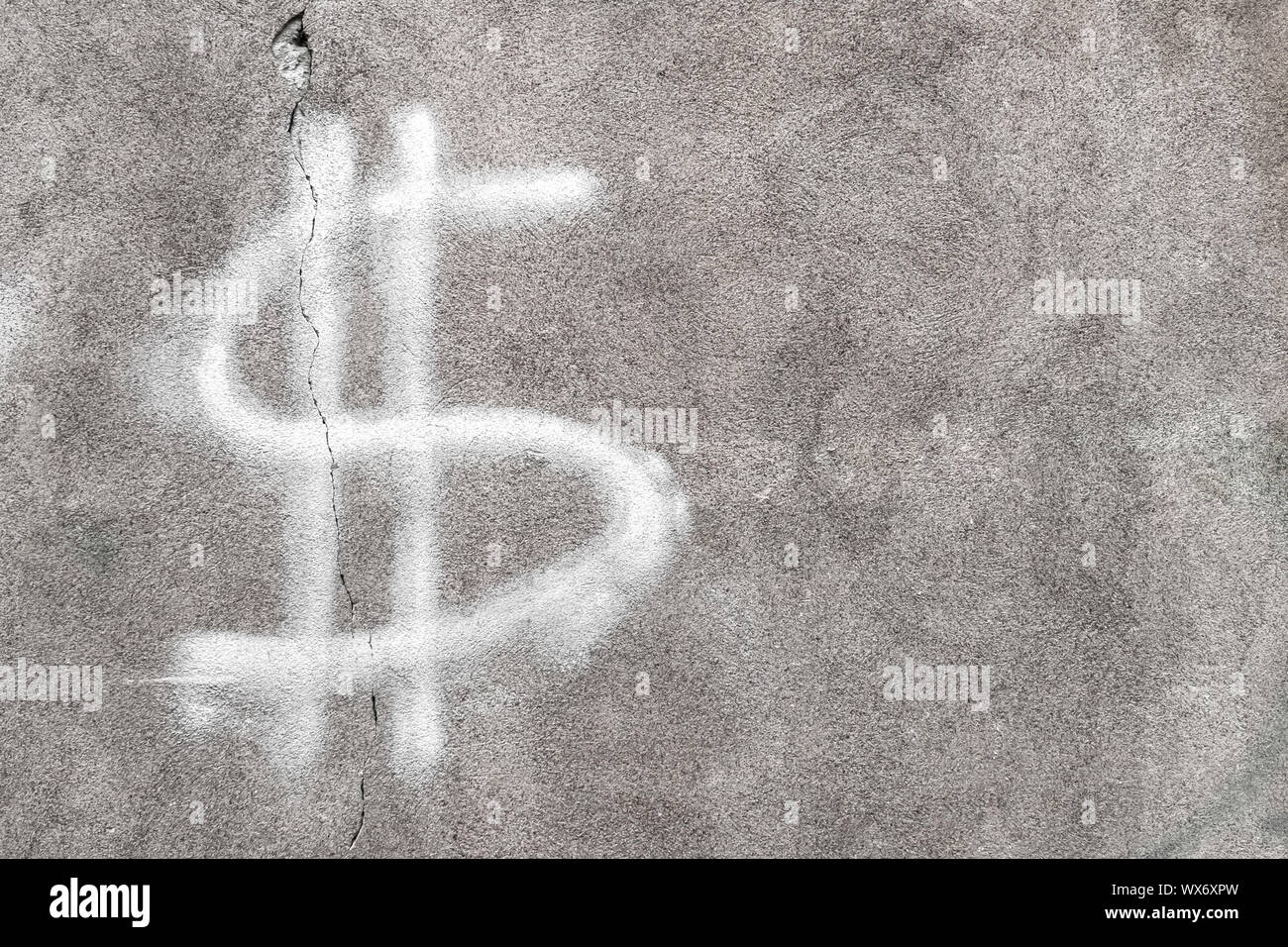 Dollar sign with cracks on wall Stock Photo - Alamy