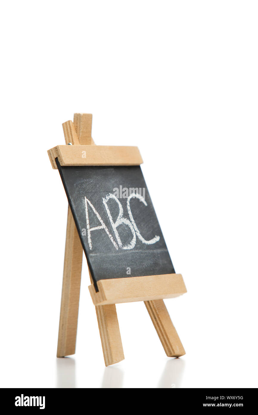 Angled chalkboard with the letters abc written on it isolated against a ...