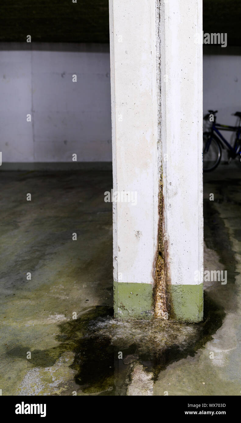water damage in concrete construction with calcium and rust deposits ...