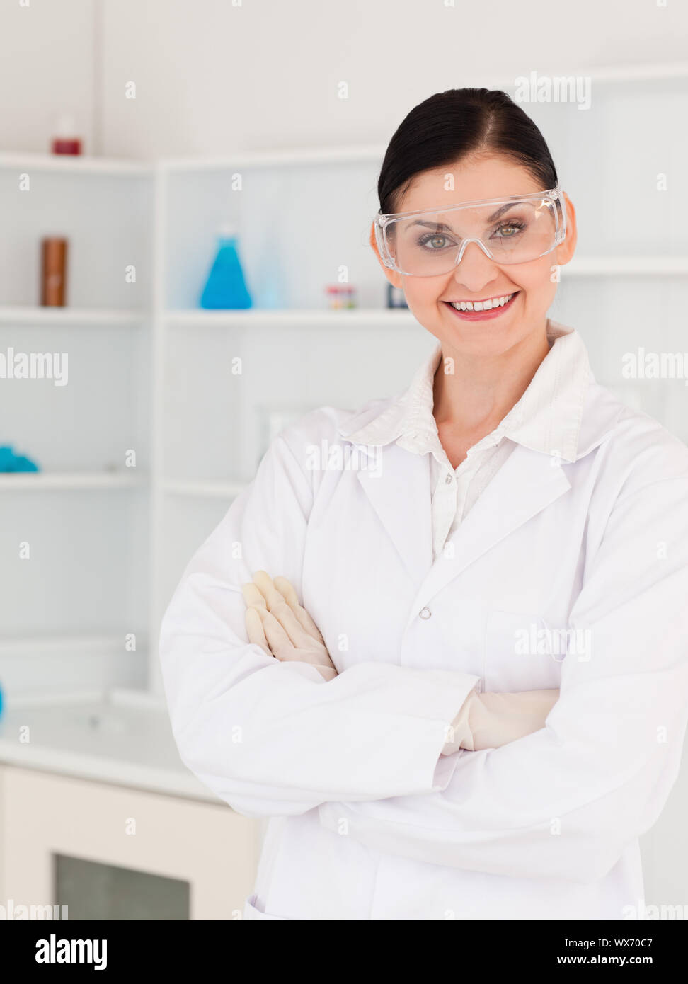 Dark-haired woman with safety glasses posing in a lab Stock Photo - Alamy