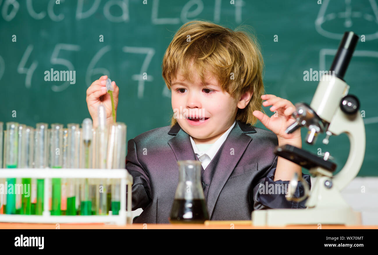 Little kid learning chemistry in lab. school kid scientist studying ...