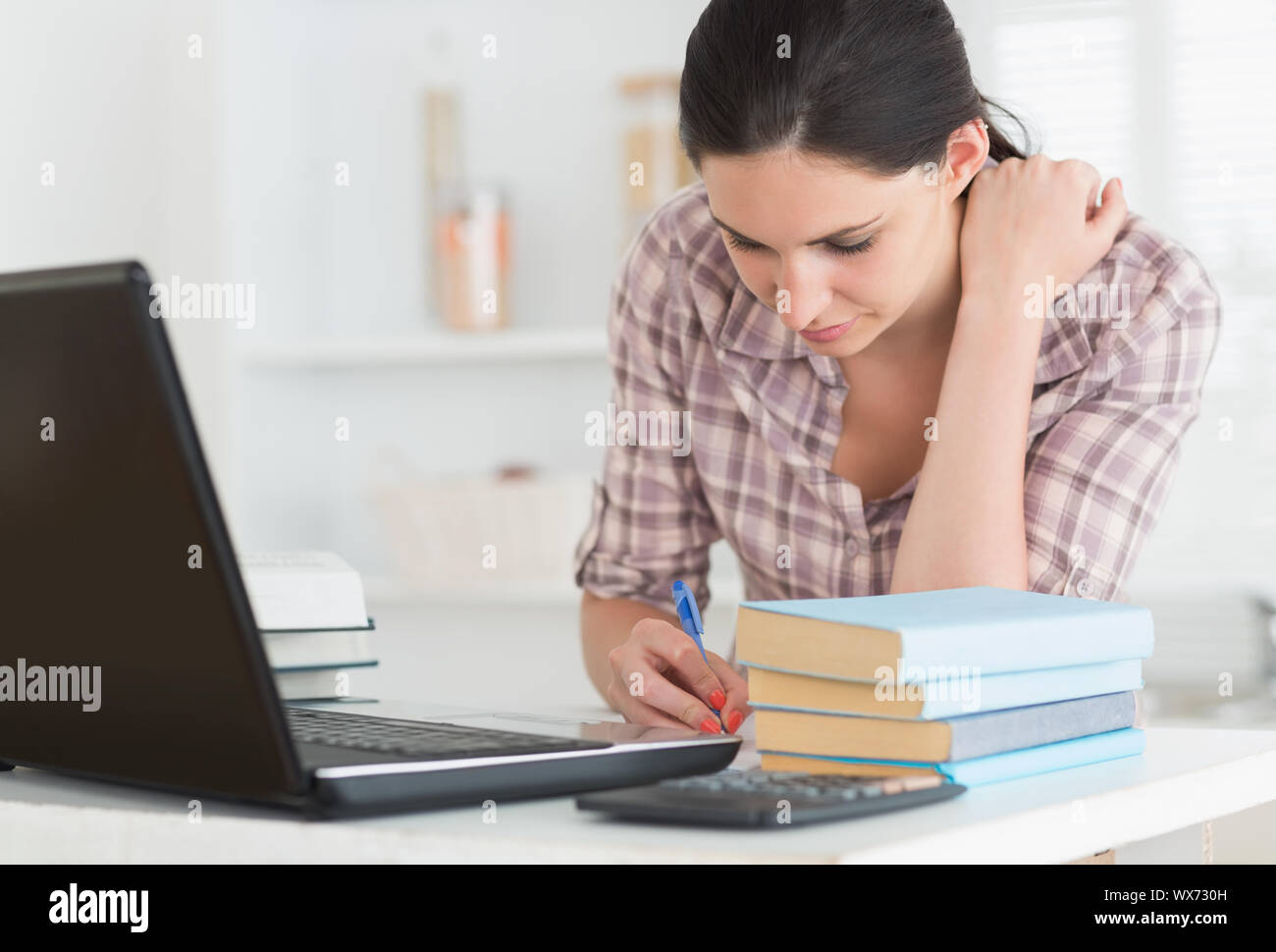 Woman Working Next To A Computer In A Living Room Stock Photo - Alamy