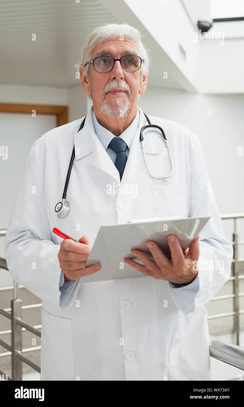 Doctor holding file in hospital corridor Stock Photo - Alamy