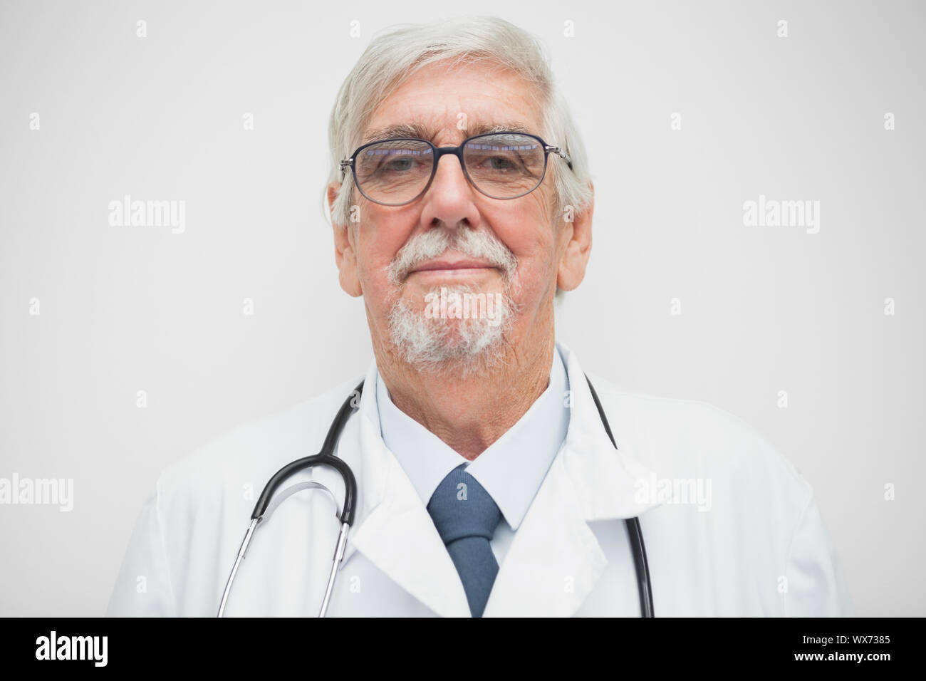 Happy bearded doctor wearing lab coat and stethoscope Stock Photo - Alamy