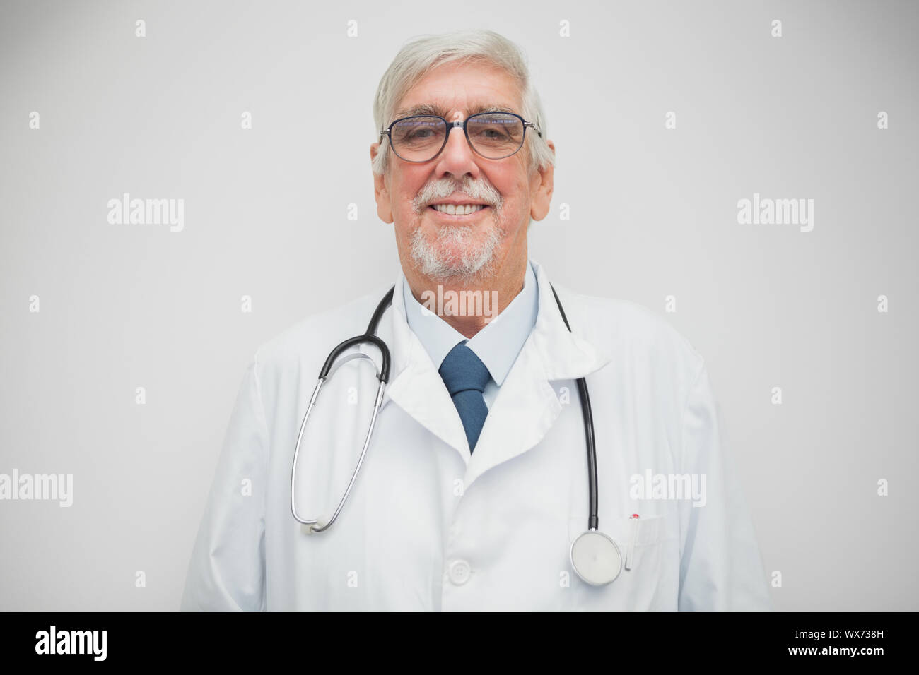 Doctor smiling into the camera standing Stock Photo - Alamy