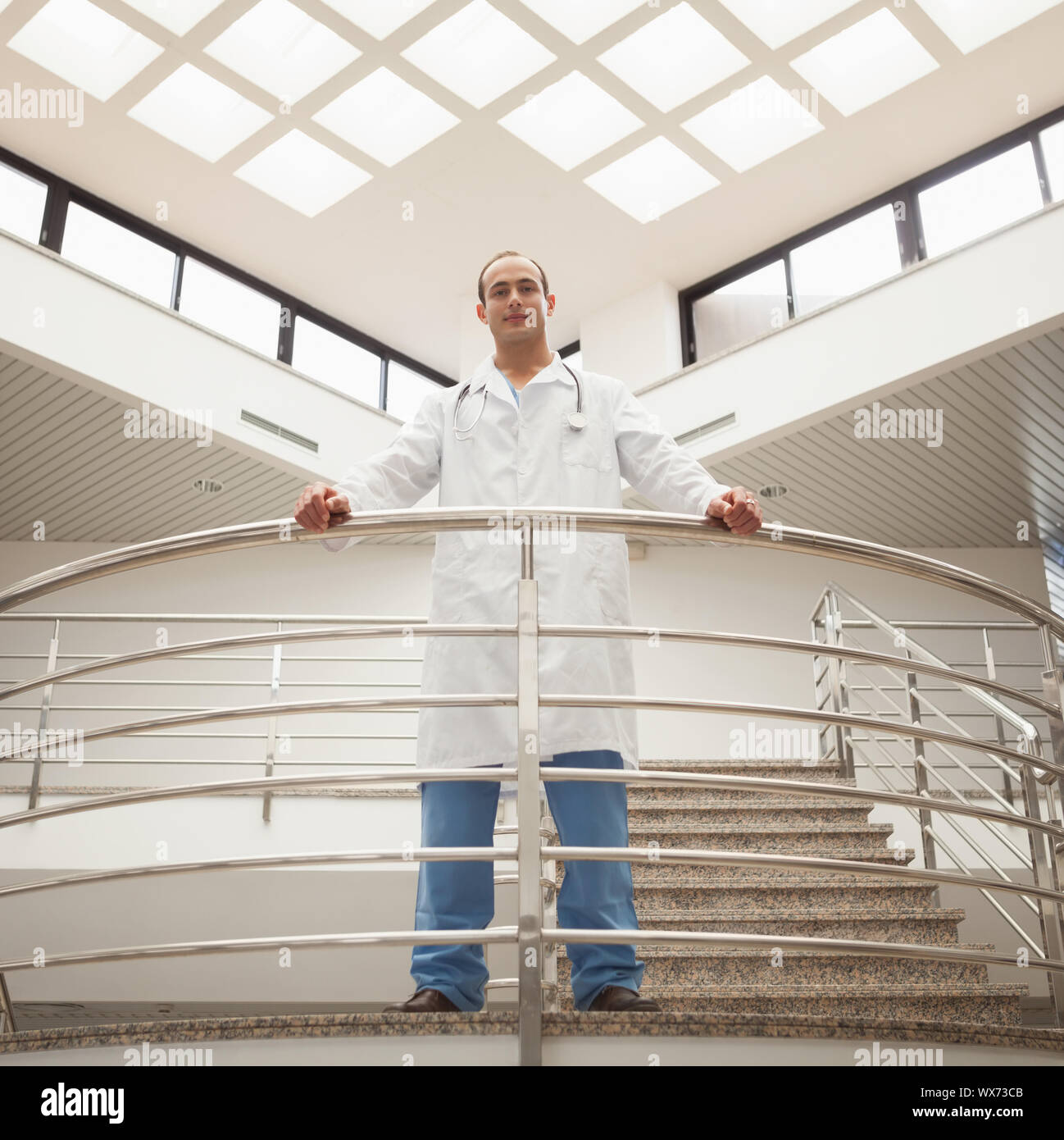Doctor looking down from stairwell in hospital Stock Photo - Alamy