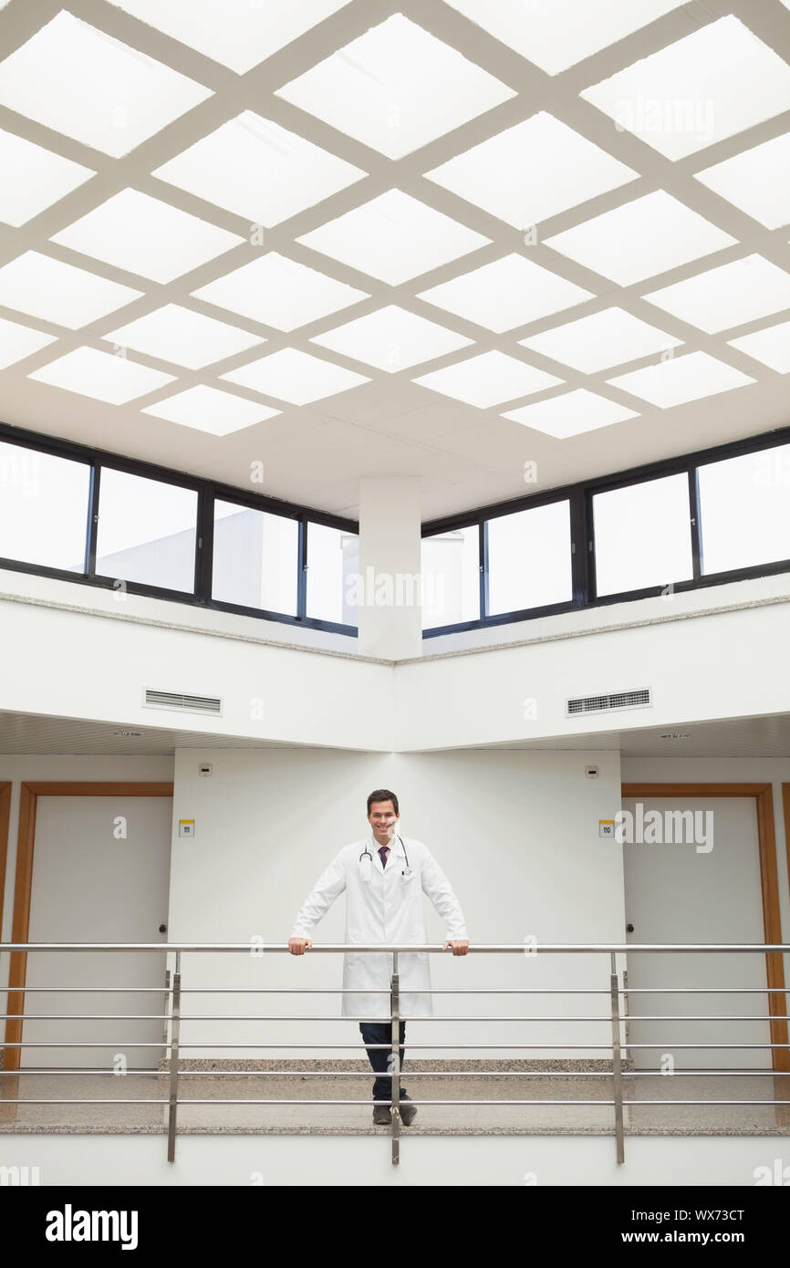 Doctor leaning on the stairwell in hospital corridor Stock Photo - Alamy