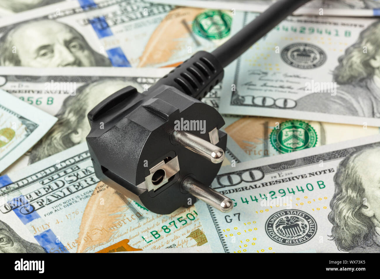 Electric plug on money Stock Photo - Alamy