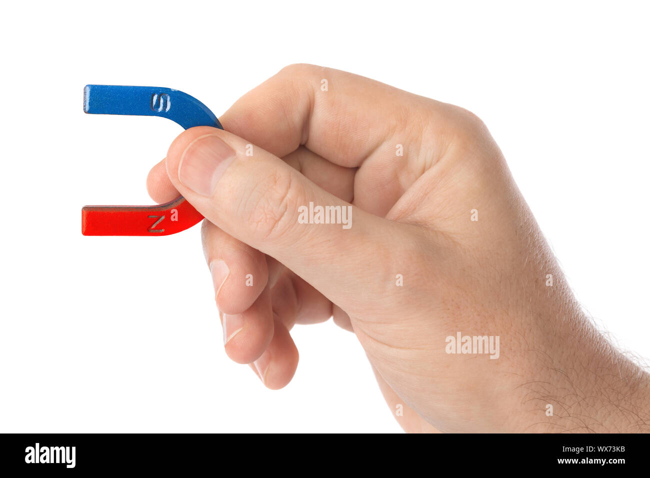 Hand with magnet Stock Photo - Alamy