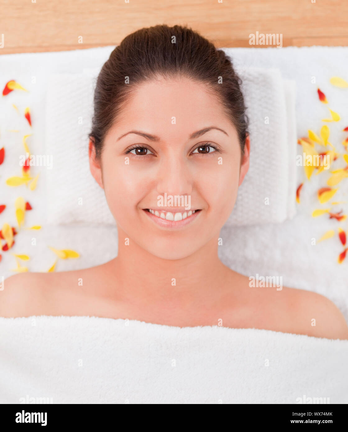 smilling woman lying on her back surrounded by flowers Stock Photo - Alamy