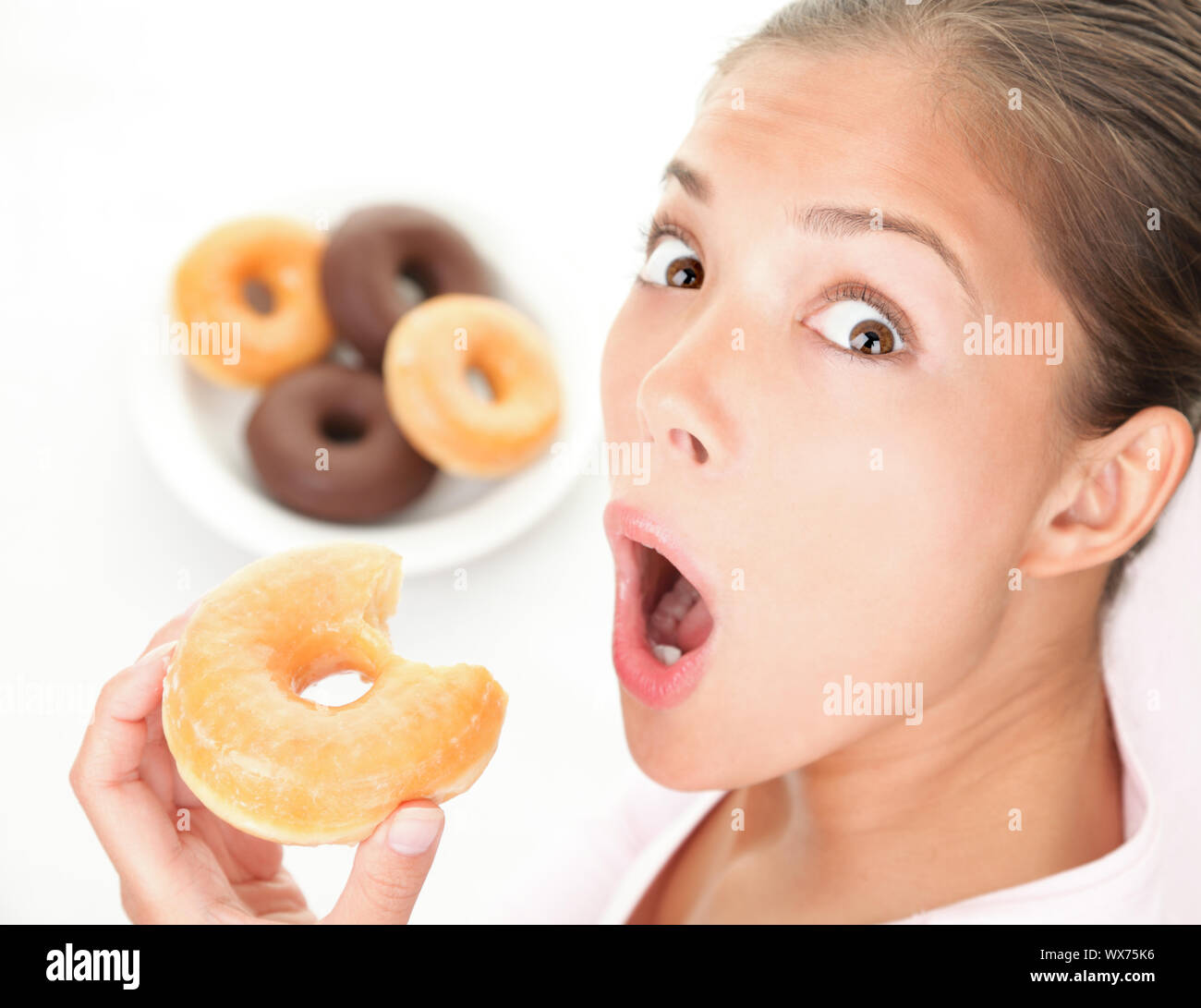 Funny woman eating junk food Stock Photo - Alamy