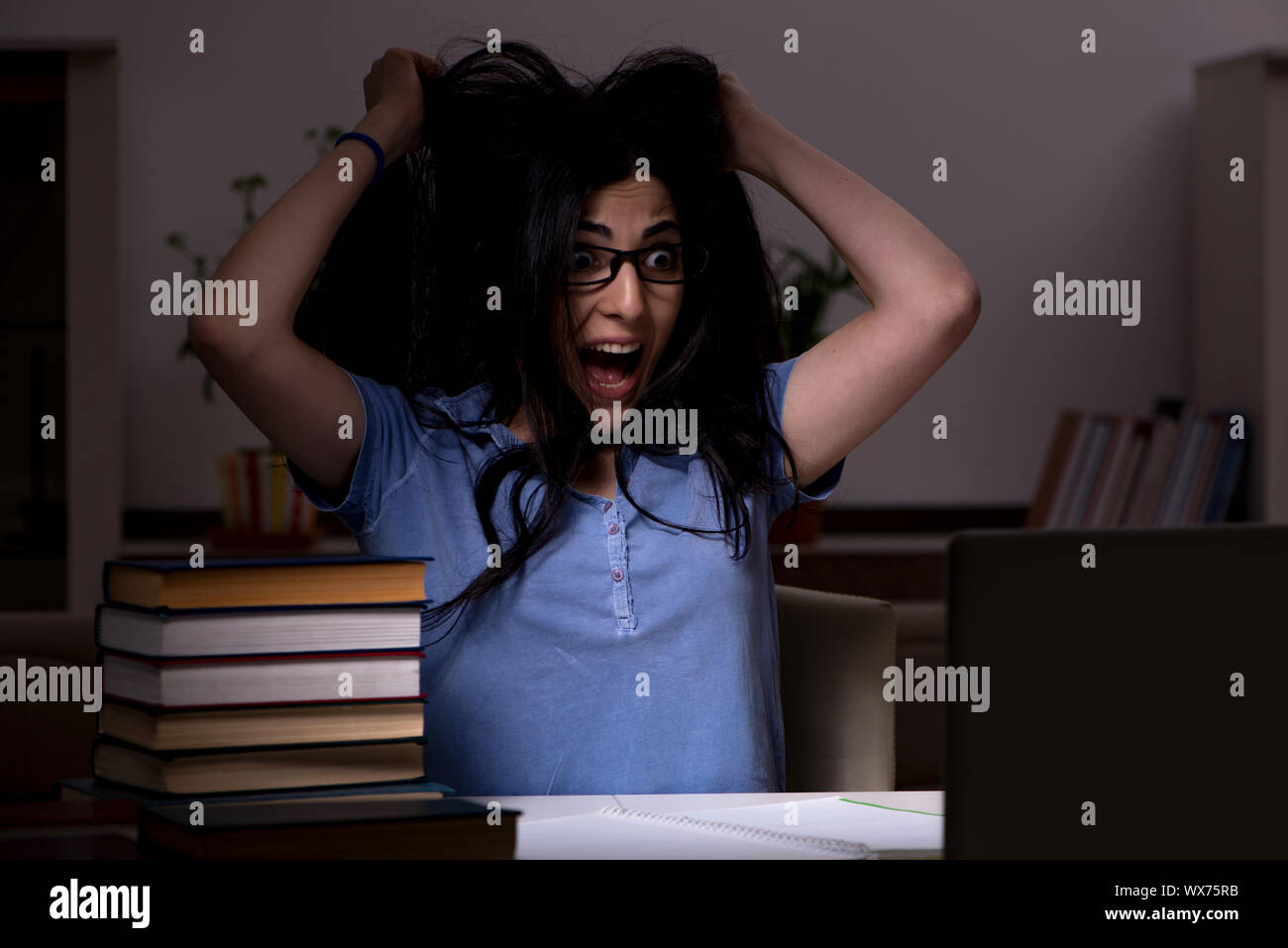 Young female student preparing for exams at night time Stock Photo - Alamy