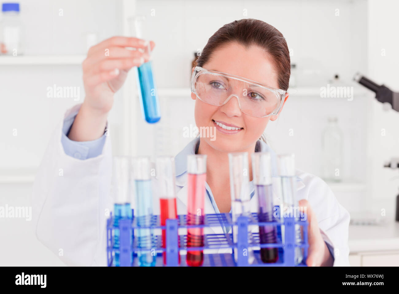 Young scientist looking at test tubes Stock Photo - Alamy