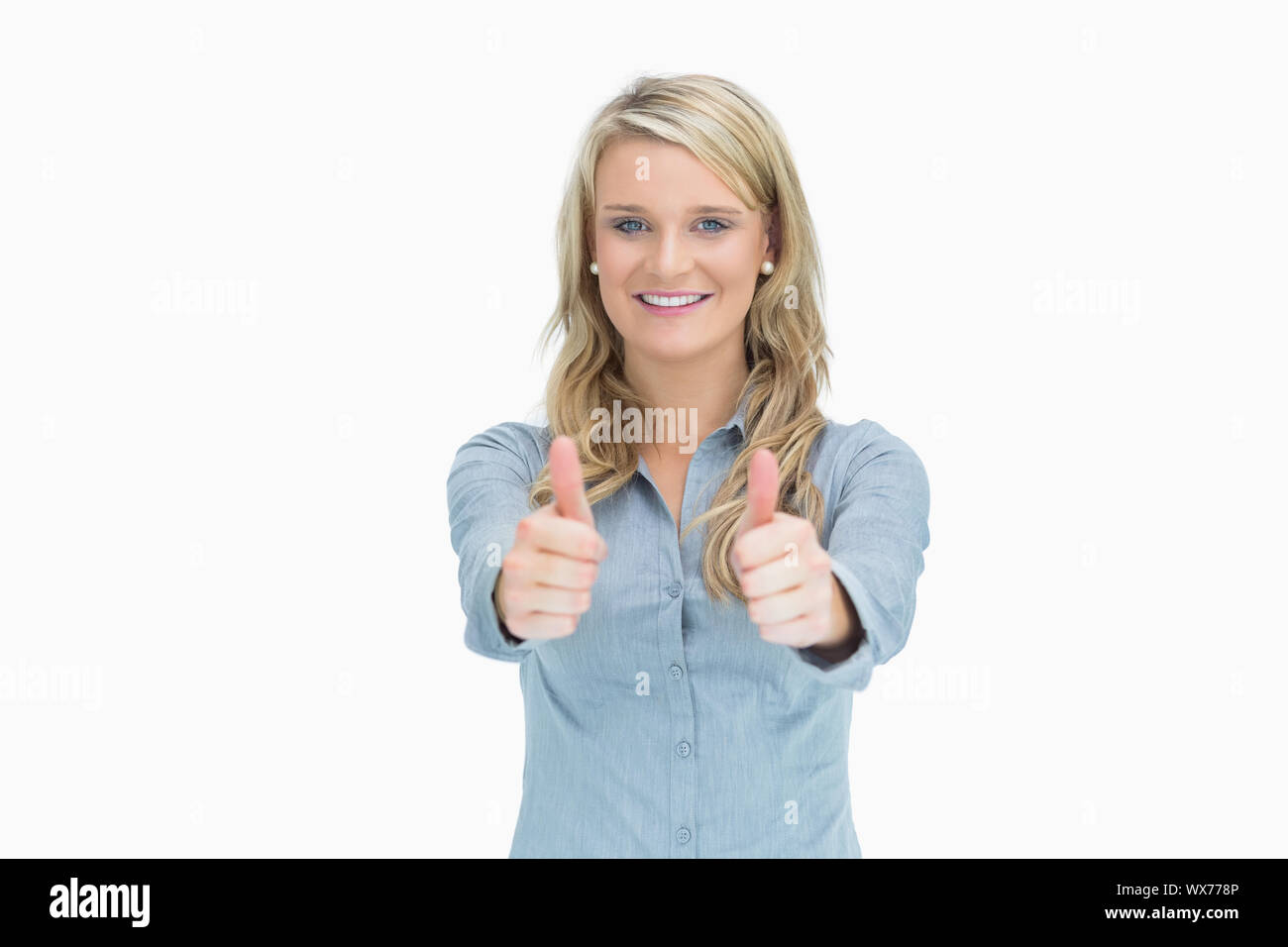 Blonde woman doing thumbs up Stock Photo - Alamy