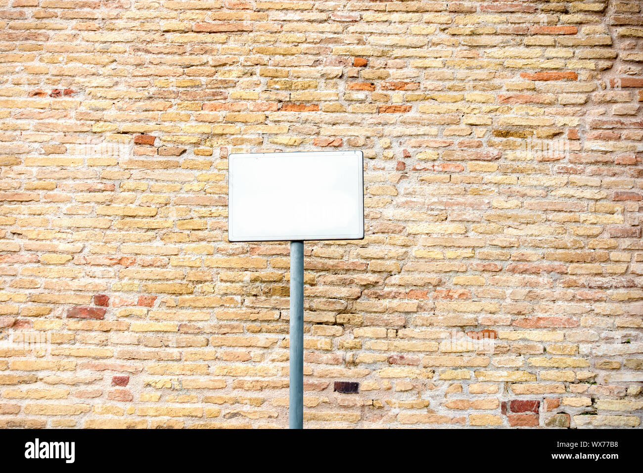 typical red brick wall background with blank white plaque Stock Photo ...
