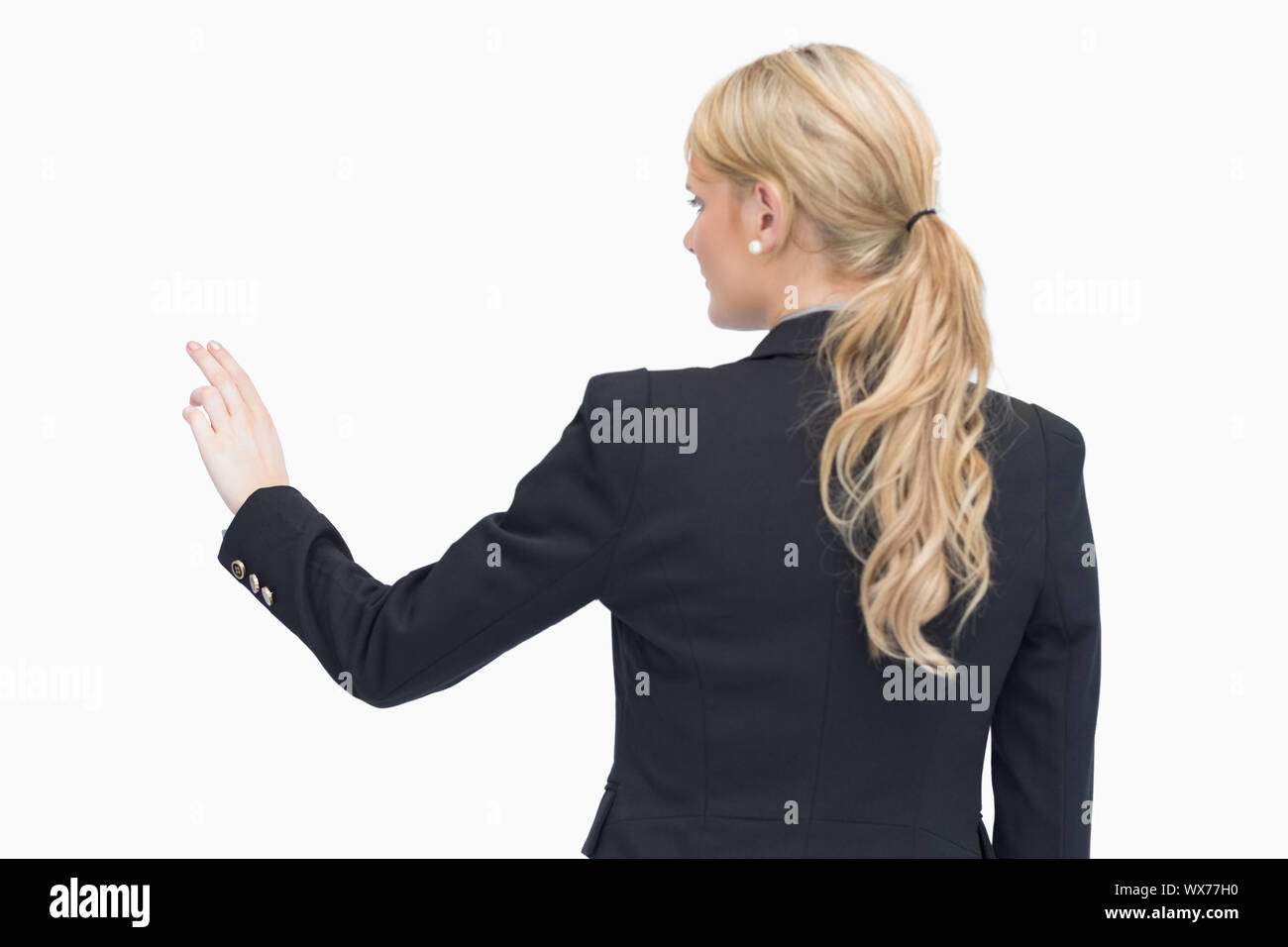 Standing businesswoman pointing something out from behind Stock Photo ...