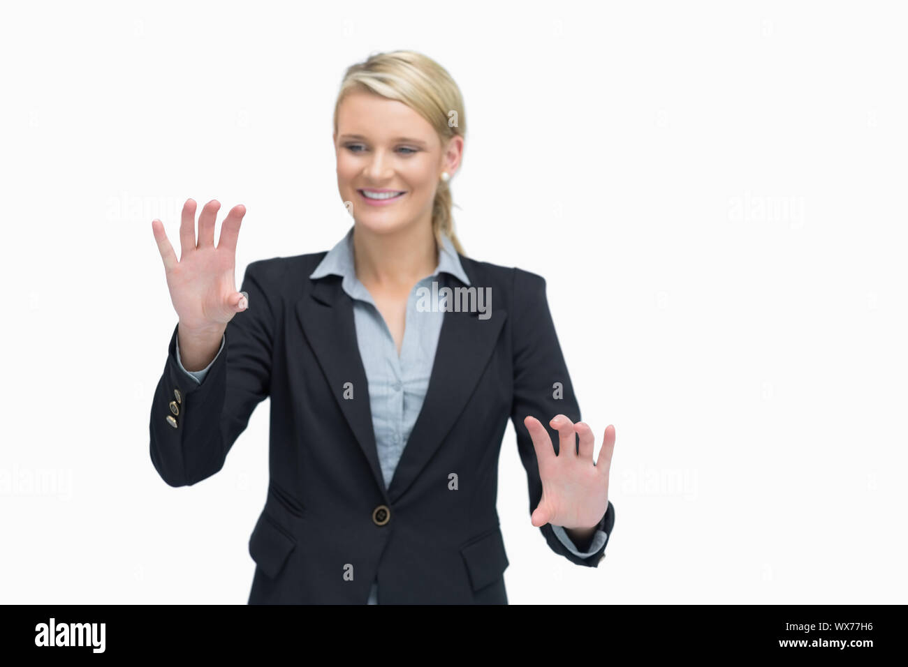 Smiling business woman presenting with both hands Stock Photo - Alamy