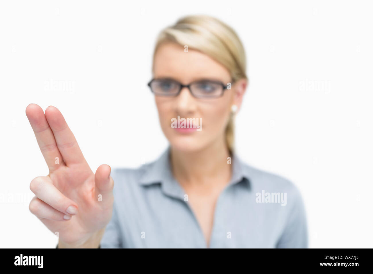 Businesswoman wearing glasses using two fingers to point Stock Photo ...