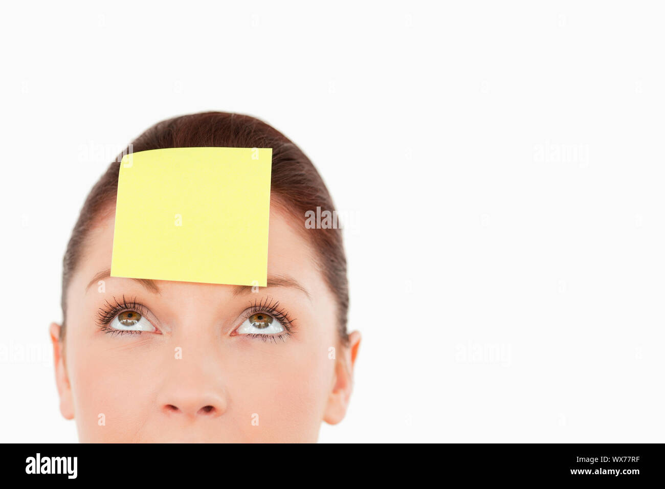 Cute woman with a sign on her forehead against a white background Stock ...
