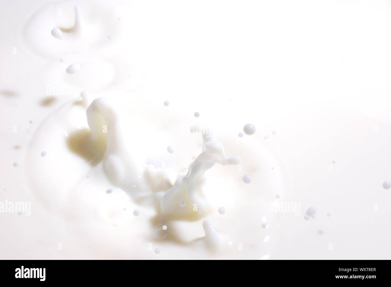 drops of milk splashing in fresh milk Stock Photo - Alamy