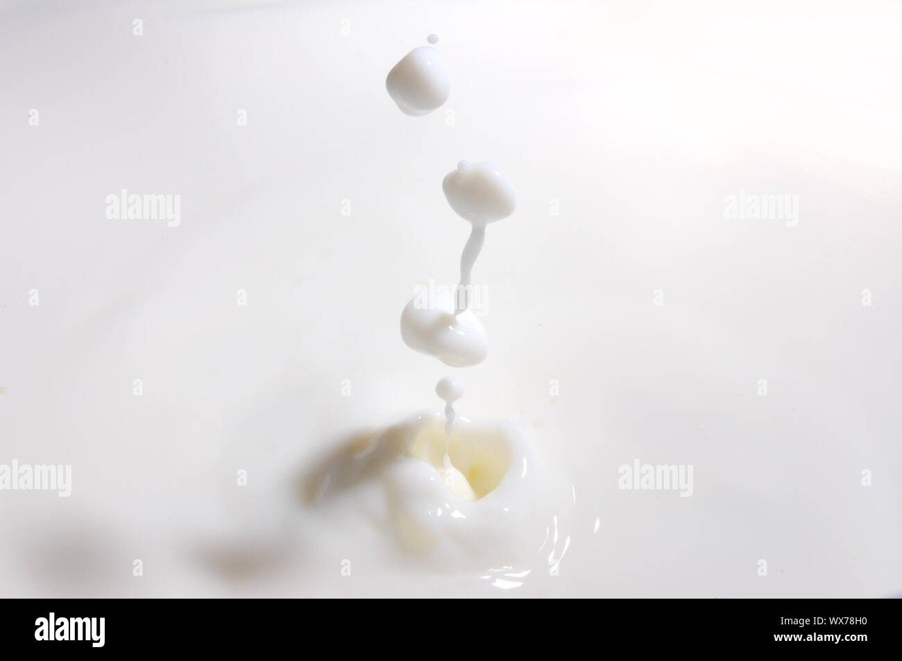 Dropping milk white liquid drops hi-res stock photography and images ...