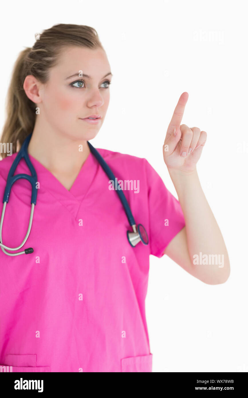 Doctor pointing to something wearing pink scrubs Stock Photo - Alamy