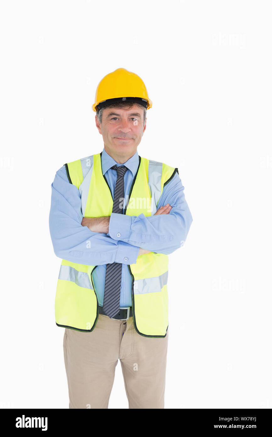 Architect wearing hardhat and high visibility vest with arms crossed ...