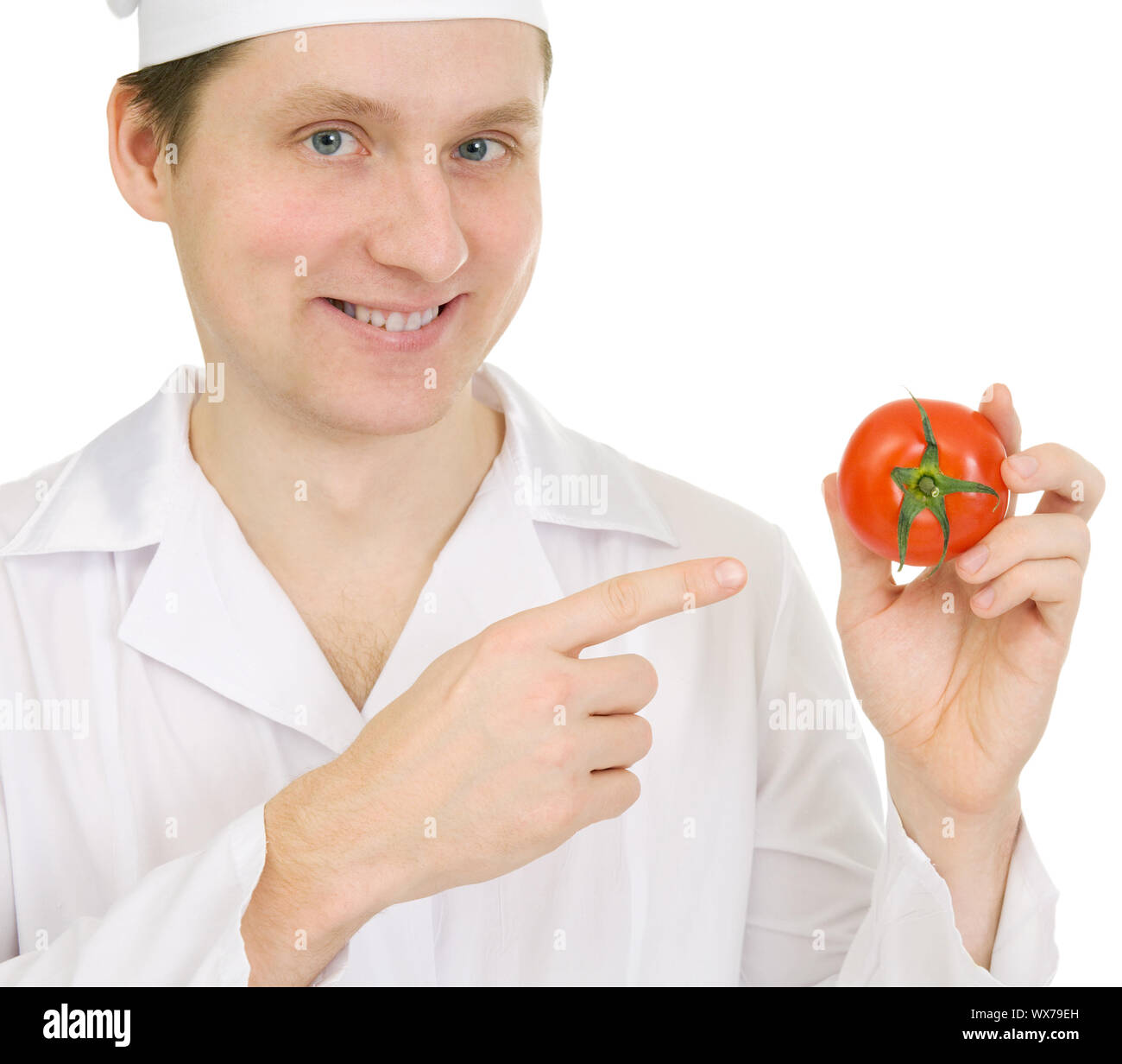 Cook in white overall with tomato in hand a white background Stock ...