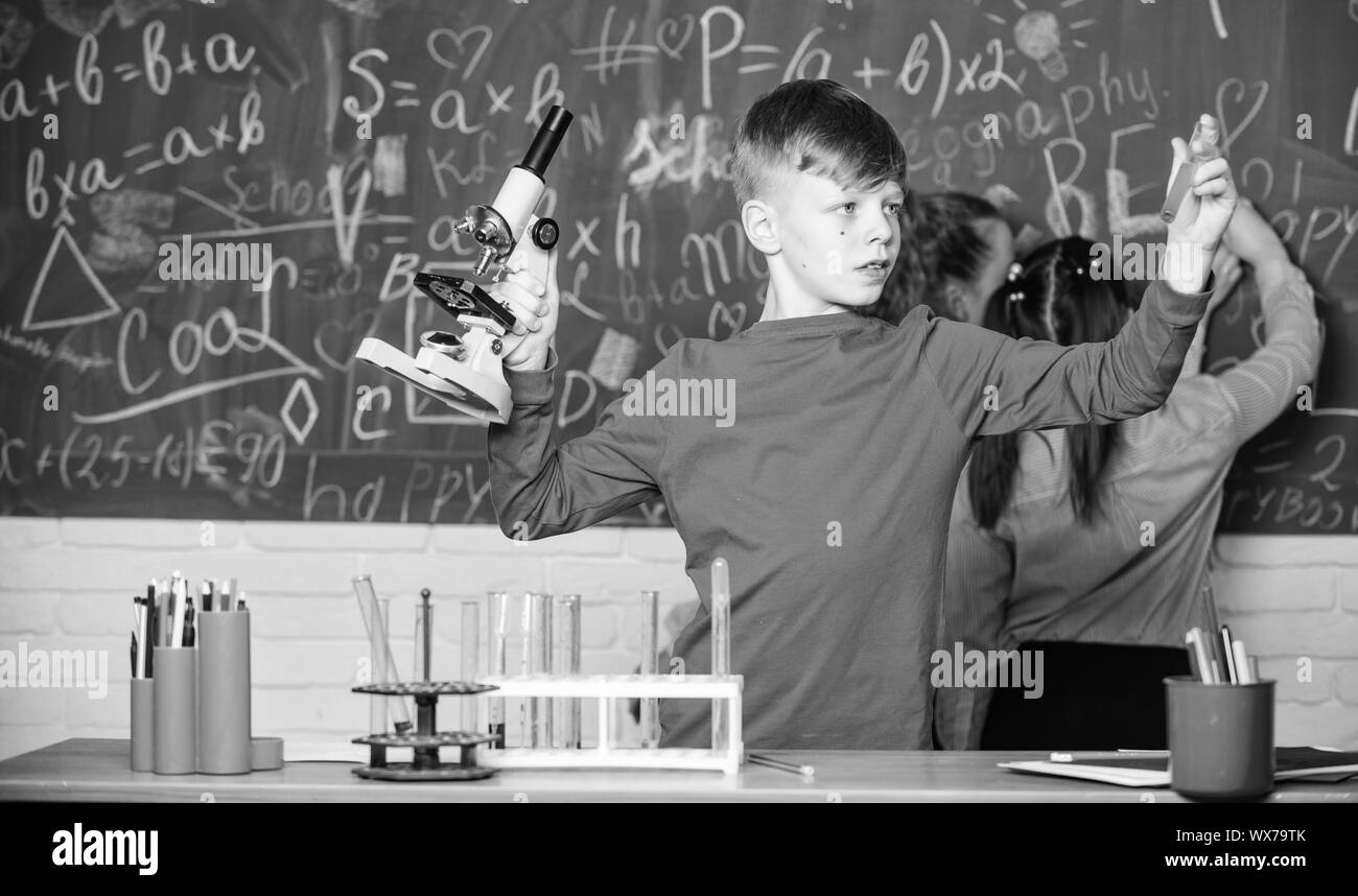students doing biology experiments with microscope in lab. Happy ...