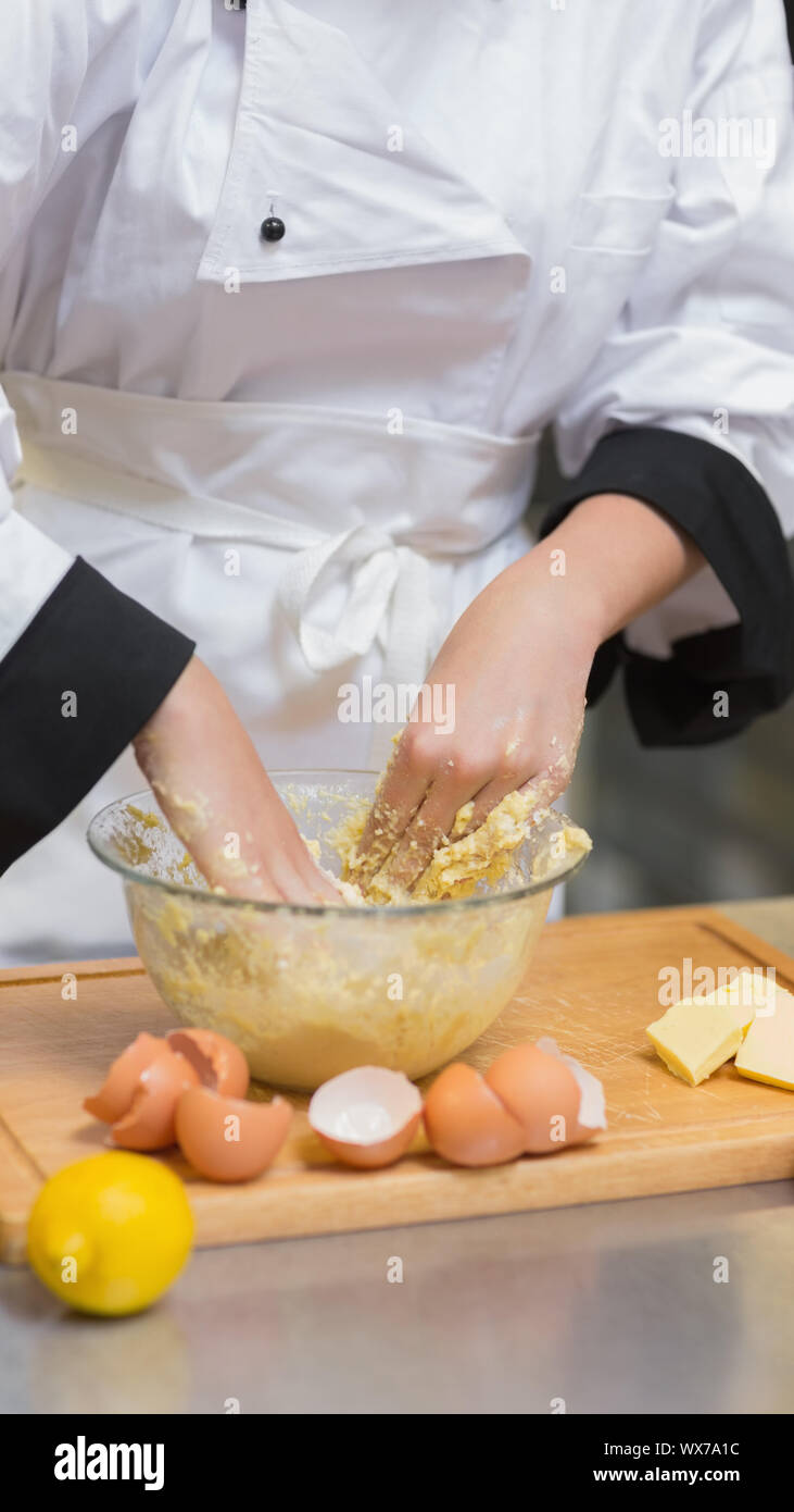 Pastry chef mixing dough with hands Stock Photo - Alamy