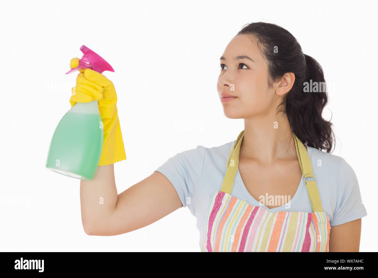 Young woman spraying cleaner in rubber gloves and apron Stock Photo - Alamy