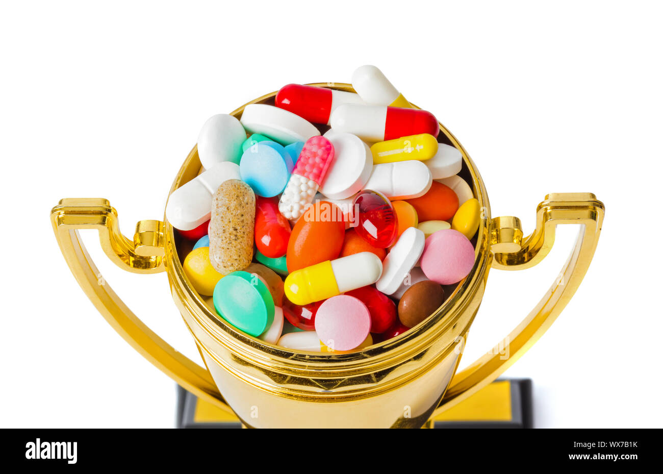Golden trophy cup with pills Stock Photo - Alamy