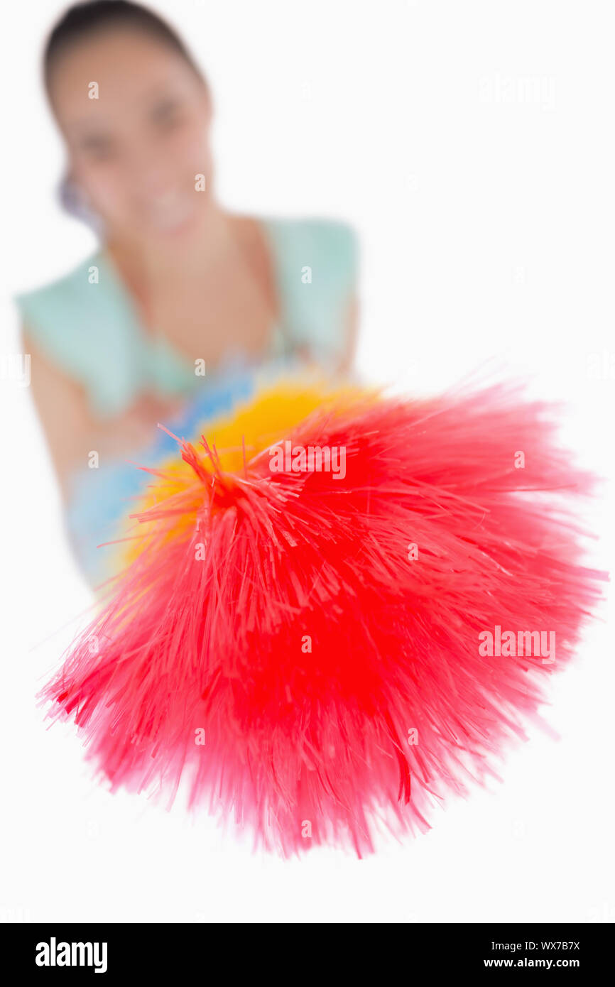 Woman pointing a duster at the camera on a white background Stock Photo ...