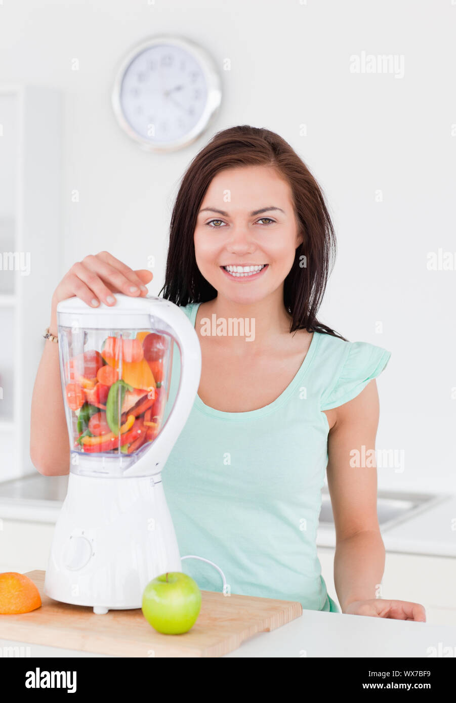 Charming woman posing with a blender in her kitchen Stock Photo - Alamy