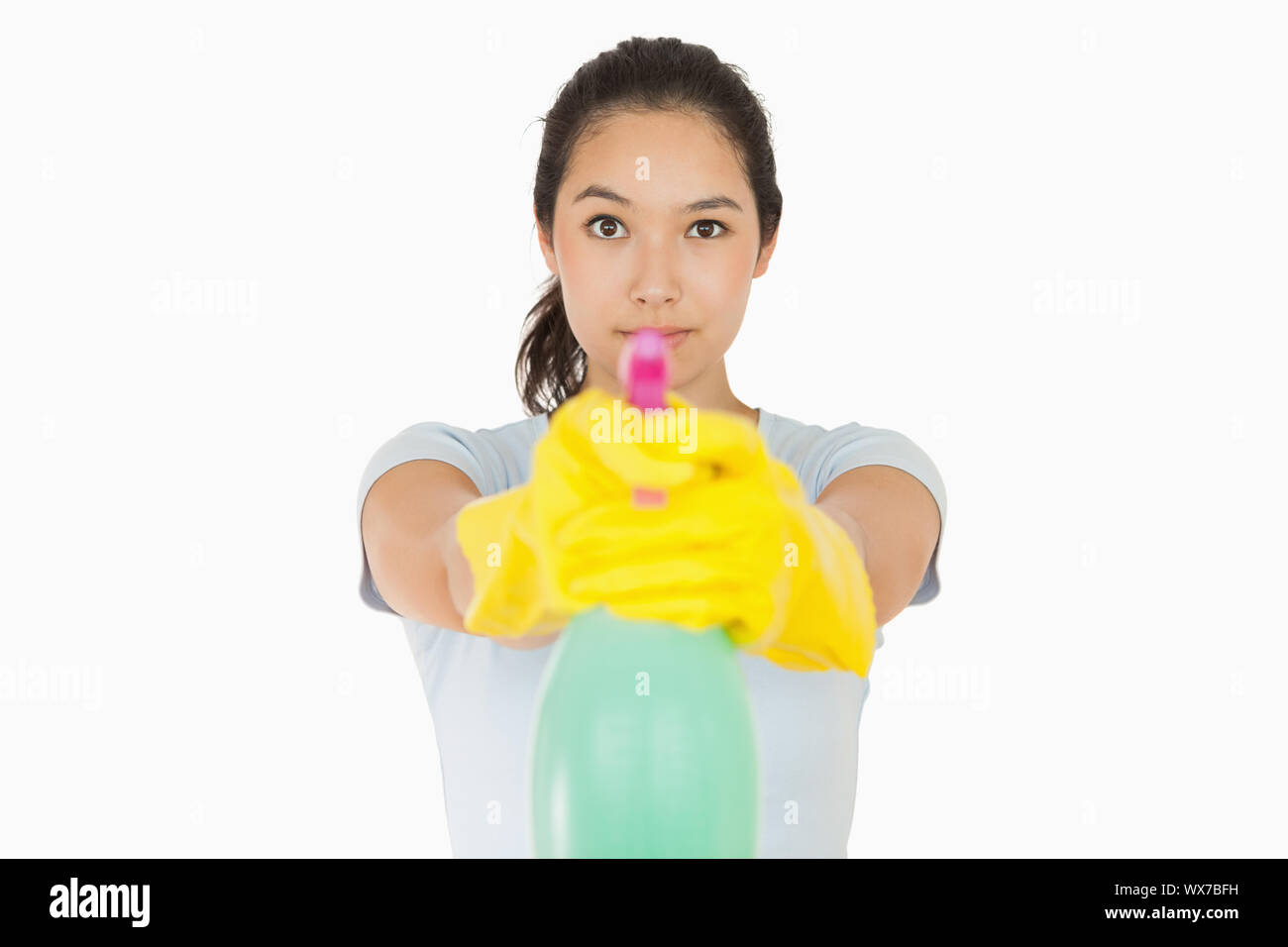 Woman pointing a spray bottle at the camera on a white background Stock ...