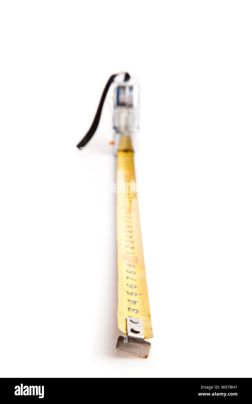 Yellow measuring tape rolled out Stock Photo - Alamy