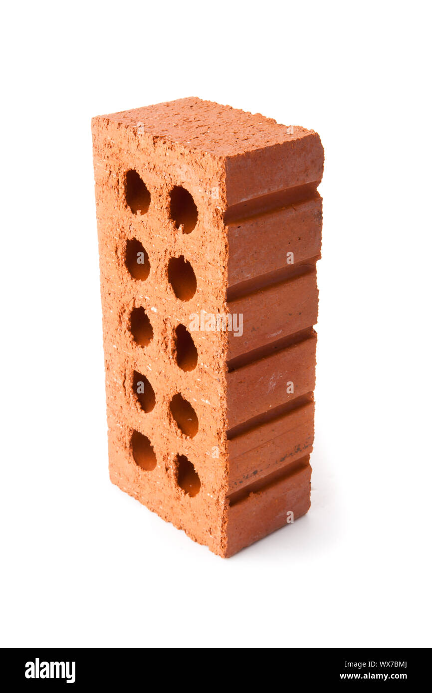 Standing clay brick with ten holes in it against a white bakground ...