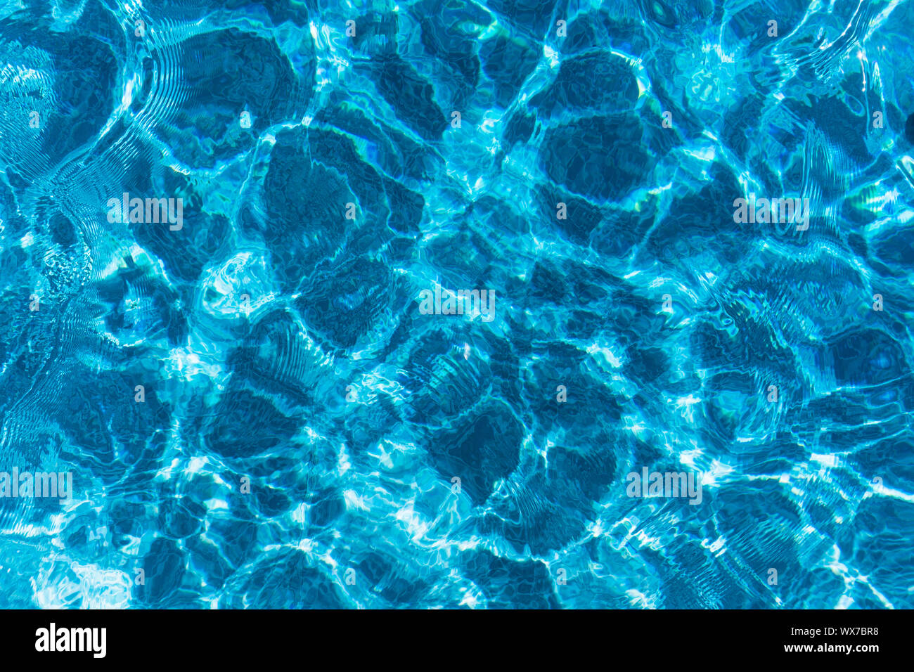 Light ripples in clear swimming pool water on a hot sunny day Stock ...